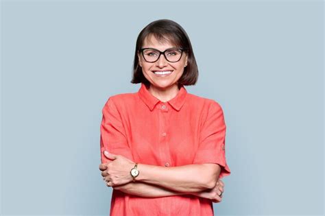 Premium Photo Portrait Of Beautiful Mature Woman In Glasses In Red