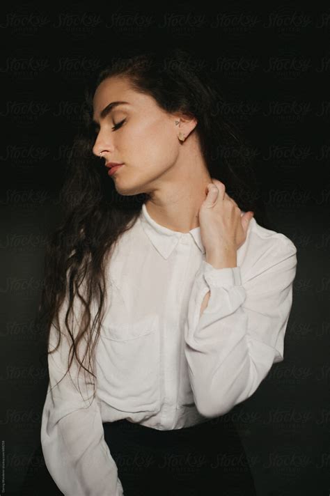 Pretty Woman In White Button Up Shirt Septum Piercing And Long Dark Hair By Stocksy