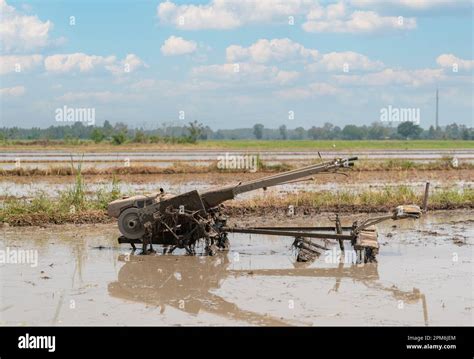 wheel cultivator tractor park in the mud field farmer break working