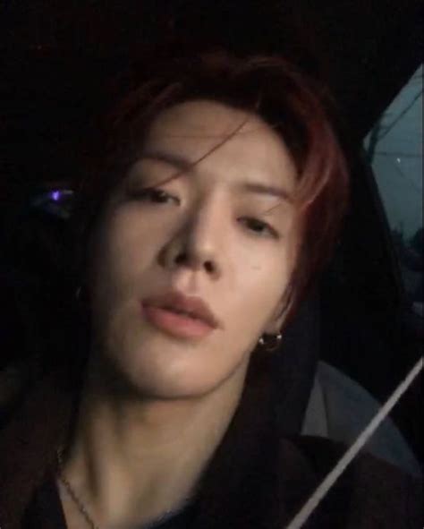 A Woman With Red Hair Is Sitting In The Back Seat Of A Car And Has Her