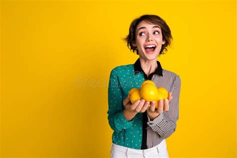 Photo Of Excited Adorable Woman Wear Stylish Clothes Hold Lemon Look Empty Space Isolated On