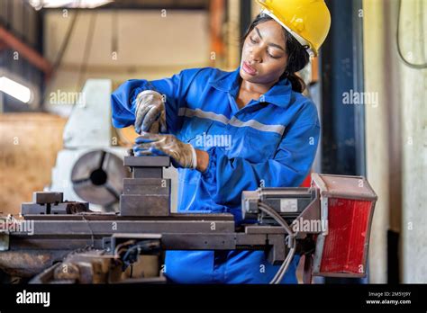 Woman Worker In Uniform Operating Machine At Factory Concentrate On