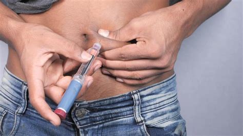 A Man Is Holding A Needle To His Stomach 49848899 Stock Video At Vecteezy