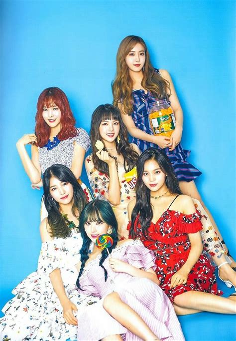 The Girls Are Posing For A Photo In Front Of A Blue Background And One