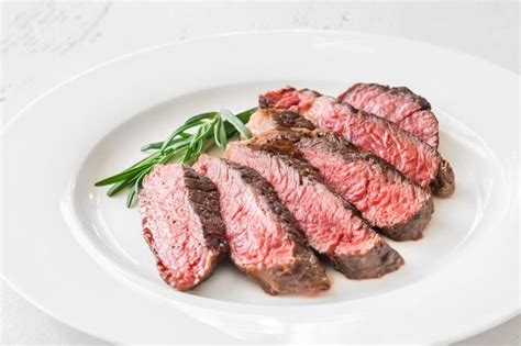 Premium Photo Sliced Rib Eye Steak On White Background Medium Rare