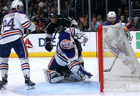 Kyle Clifford Of The Los Angeles Kings Knocks Down Goalie Ben Los