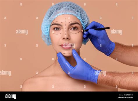 Doctor Drawing Marks On Womans Face For Cosmetic Surgery Operation