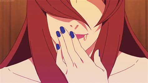 A Woman With Red Hair And Blue Nails Covers Her Face As She Holds Her