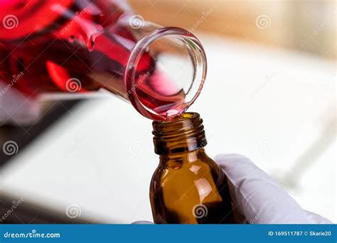 Researcher Is Pouring Chemicals Into Bottles Scientist Working At The Laboratory Stock Image