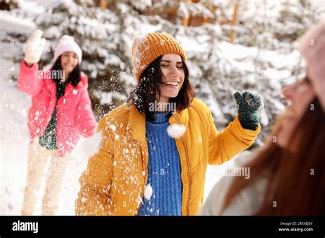 Group Of Friends Playing Snowballs Outdoors Winter Vacation Stock