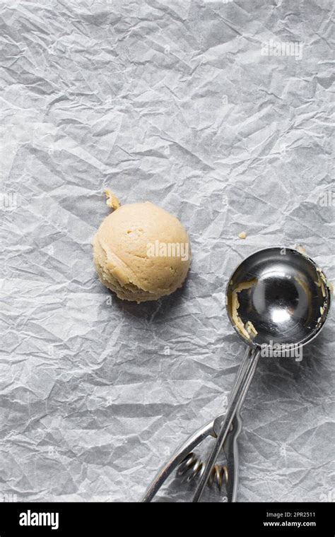 Scoops Of Vanilla Cookie Dough On A Parchment Lined Cookie Sheet Plain