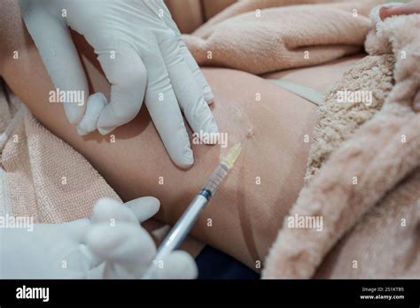 Closeup Of Medical Specialist Administering An Injection With Syringe Bacterial Toxin Botulin