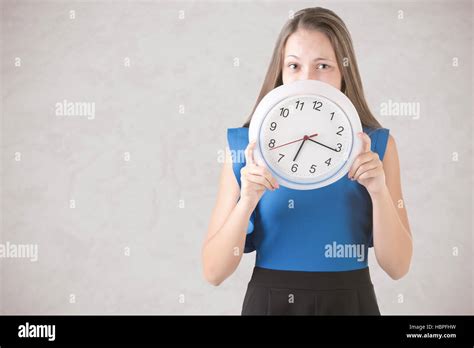 Woman Hiding Behind Clock Stock Photo Alamy