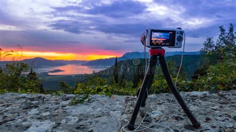 Camera Capturing Sunset Shot Photography Using On Tripod Against Sun