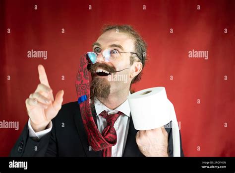 Happy Man With Glasses Red Tie On His Head And Toilet Paper In Hand
