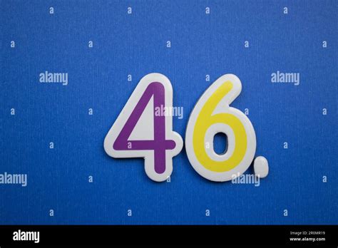 The Number 46 Placed On A Blue Background Photographed From Above