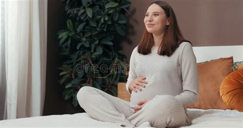 Pregnancy Glow Concept Soon To Be Mom Sits On Her Bed Her Short Hair