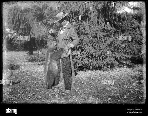 This Photograph Shows A Man With A Tame Chained Bear Highlighting The Unusual Relationship