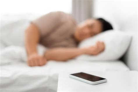 Premium Photo Asian Man Sleeping Through Ringing Phone In The Morning