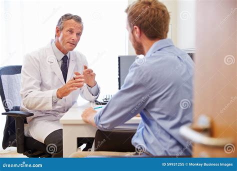 Male Patient Having Consultation With Doctor In Office Stock Image