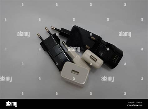 Many Phone Charger Adapters Of Different Types On A White Background