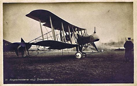 An Old Fashioned Airplane Is Parked On The Grass