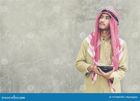 A Handsome Arab Man Standing And Smiling Wearing Uae Emirati