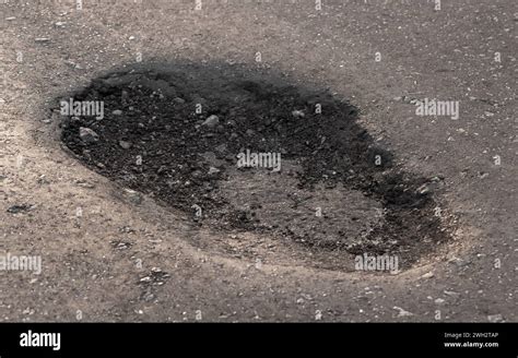 Deep Pit On The Road Poor Condition Of Asphalt Pavement On The Road