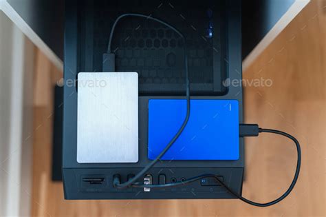 Two External Ssd Hard Drivers Connected To Stationery Computer In Home