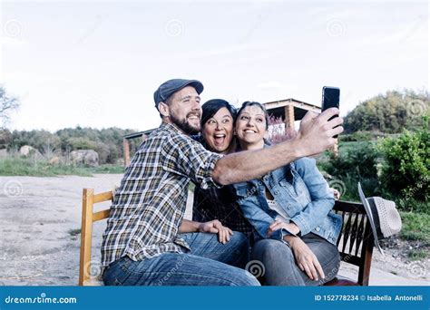 A Group Of Friends Sitting Outdoors While Taking A Selfie With Friends Stock Photo Image Of