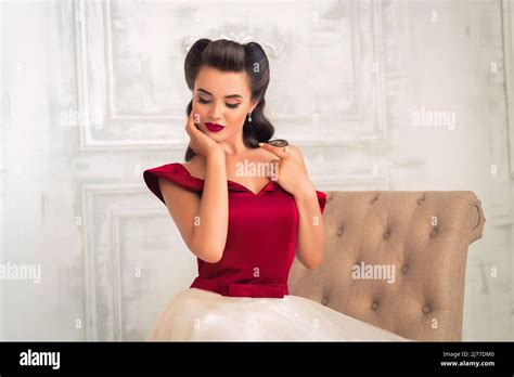 Beautiful Flirtatious Girl As A Pin Up Model In Dress In Retro Interior