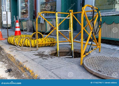 Manhole Opened With Ladder Going Down And Safety Rails Editorial Photo