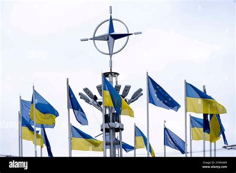 Ukrainian And European Flags With The Nato Compass Rose Depicted In