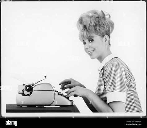 An Attentive Blonde Typist Or Secretary Poised For Dictation Over The