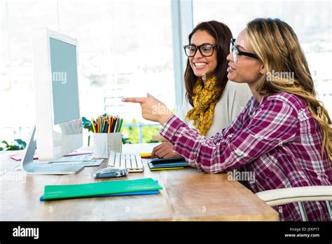 Two Girls Use A Computer Stock Photo Alamy