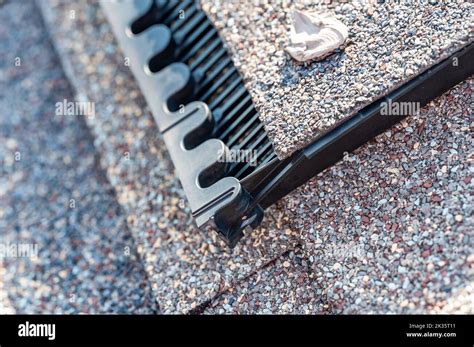 Ridge Cap Vent Installed On A Shingle Roof For Passive Attic Ventilation On A Residential House