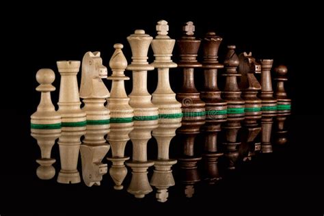Diagonal Line Of Wooden Chess Pieces Isolated At Dark Background Stock