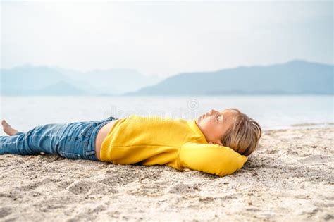 Lonely Beautiful Sad Girl Teenager Sits Thoughtfully On Sand Sea Beach