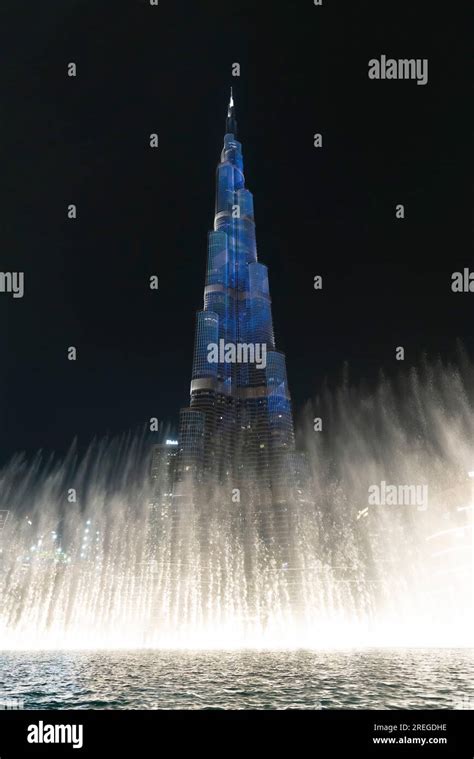 Burj Khalifa Lit Up At Night With Fountain In The Foreground Stock