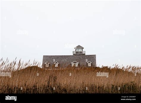 Oregon Inlet Life Saving Station Behind Dune Grass Against A White Sky