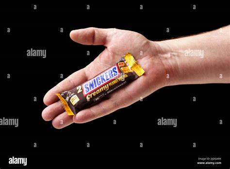 A Man Offers A Snickers Chocolate Bar Hand Holding A Chocolate Bar