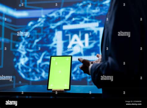 Developer Analyzing Complex Ai Brain Models On Green Screen Tablet It