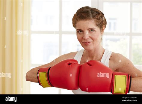 Germany Duesseldorf Portrait Of Mature Woman With Boxing Gloves