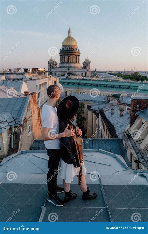A Man And Woman Hugging And Kissing On A Roof Rooftop In Saint