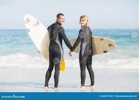 Couple With Surfboard Holding Hand On The Beach Stock Image Image Of