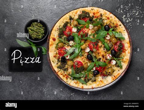 Pizza Margherita With Tomatoes Cheese Basil And Olives On A Black
