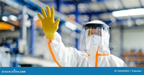 Worker With Protective Mask And Suit In Industrial Factory Greeting