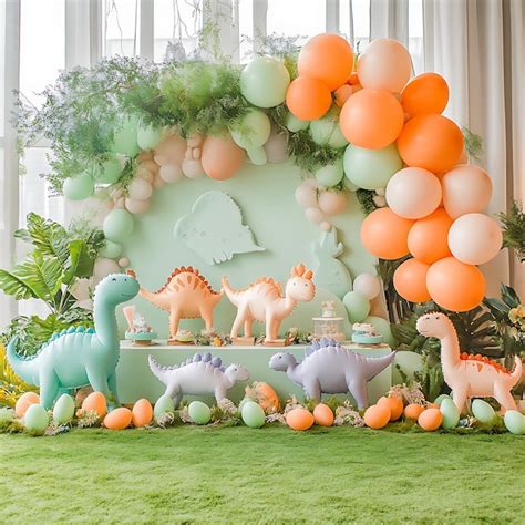 A Green And Orange Dinosaur Themed Cake With A Number Of Balloons
