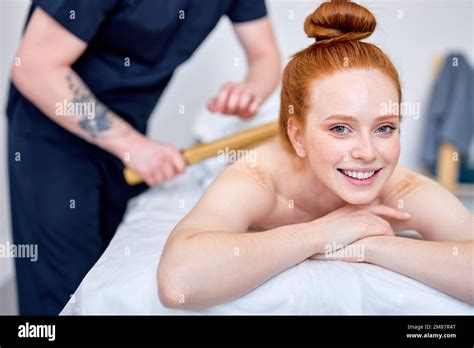 Unrecognizable Professional Masseur Massaging Back Of Pleased Client