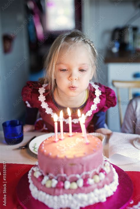 Girl Blowing Out Candles On Birthday Cake Stock Foto Adobe Stock